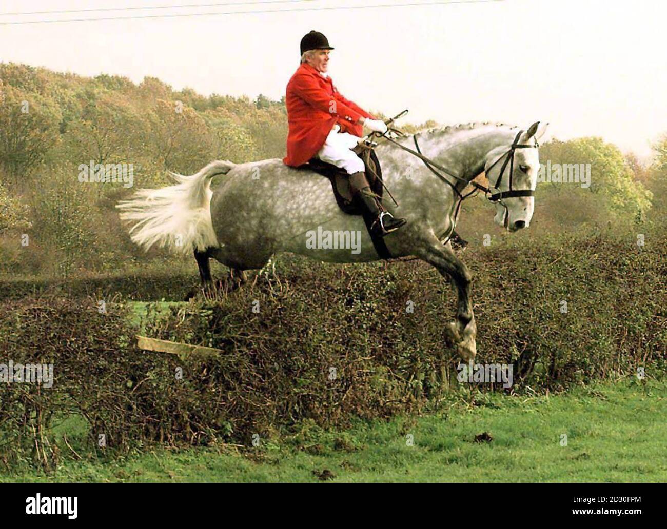 A fox hunter clears a hedge during the First Meet of the Sinnington ...