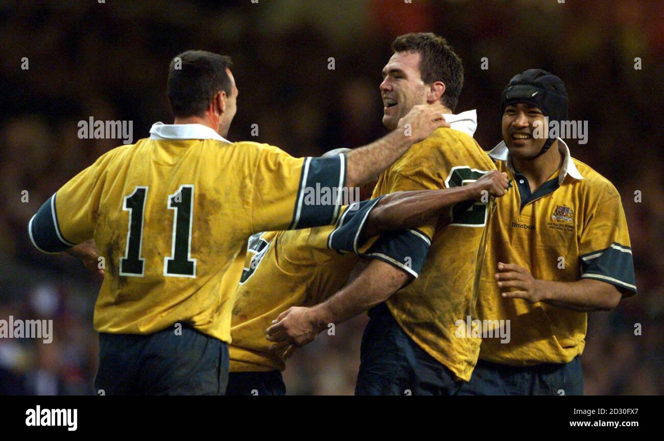 Owen Finegan (centre right) celebrates after scoring Australia's second ...