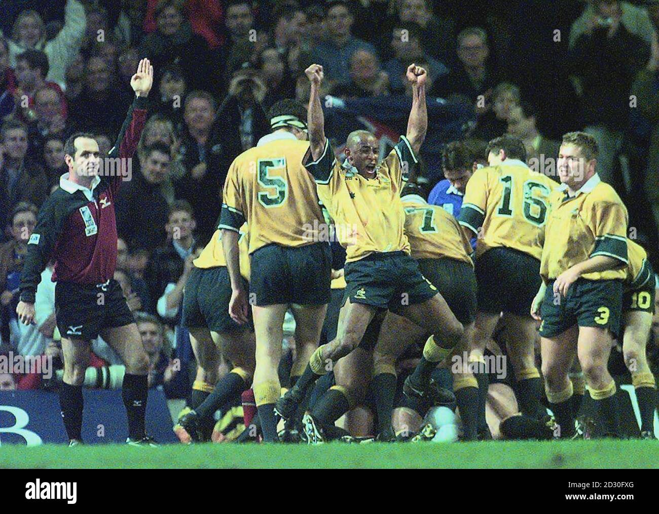 The Australia scrum half George Gregan (centre) celebrates Owen Finegan ...