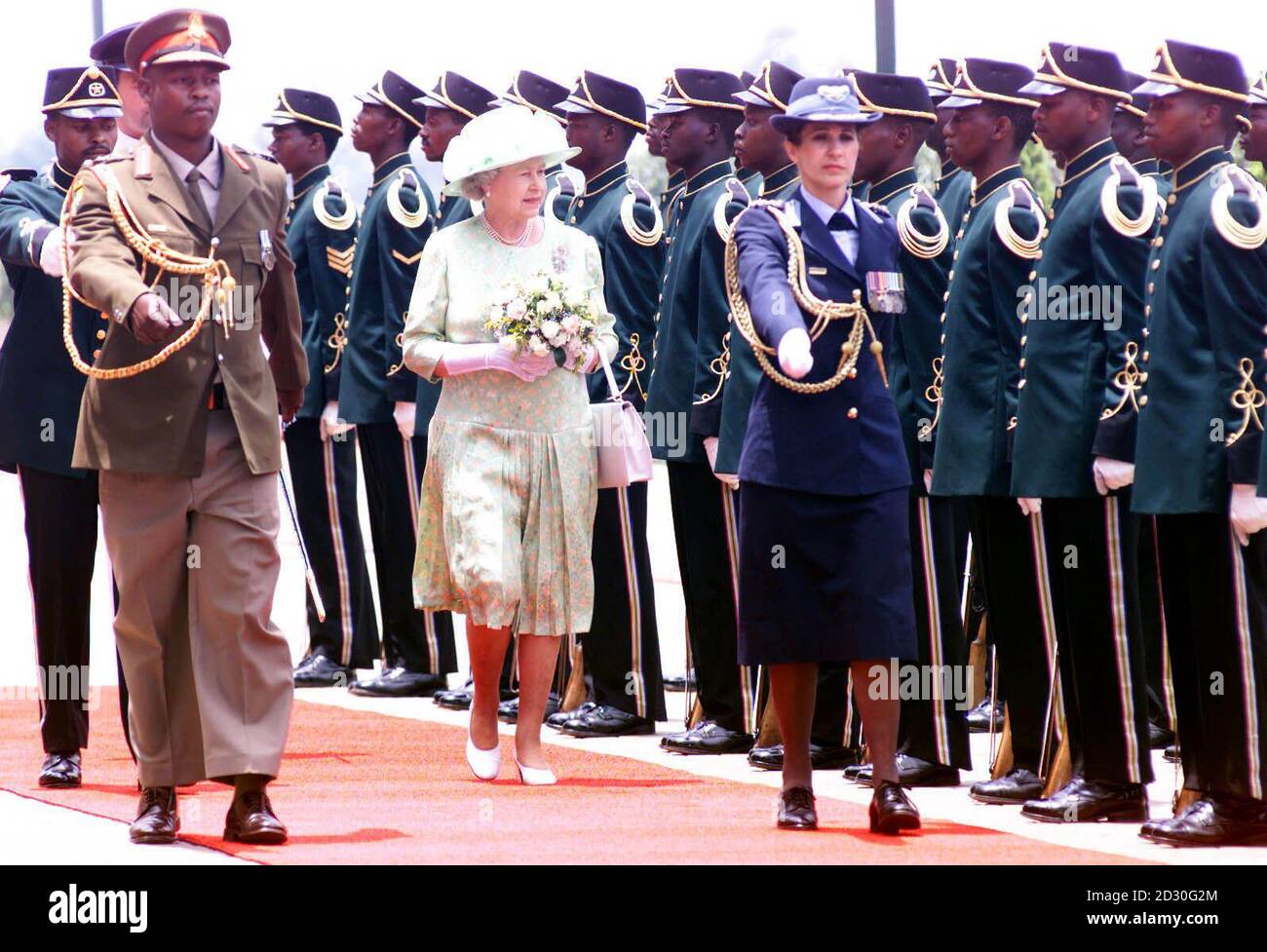 The Queen (centre) inspecting a Presidential guard of honour, made up ...