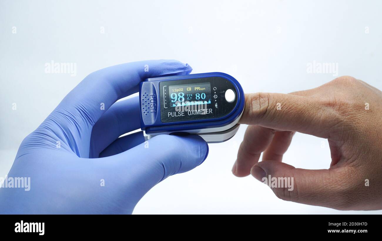 Pulse oximeter used to measure pulse rate and oxygen levels Stock Photo ...