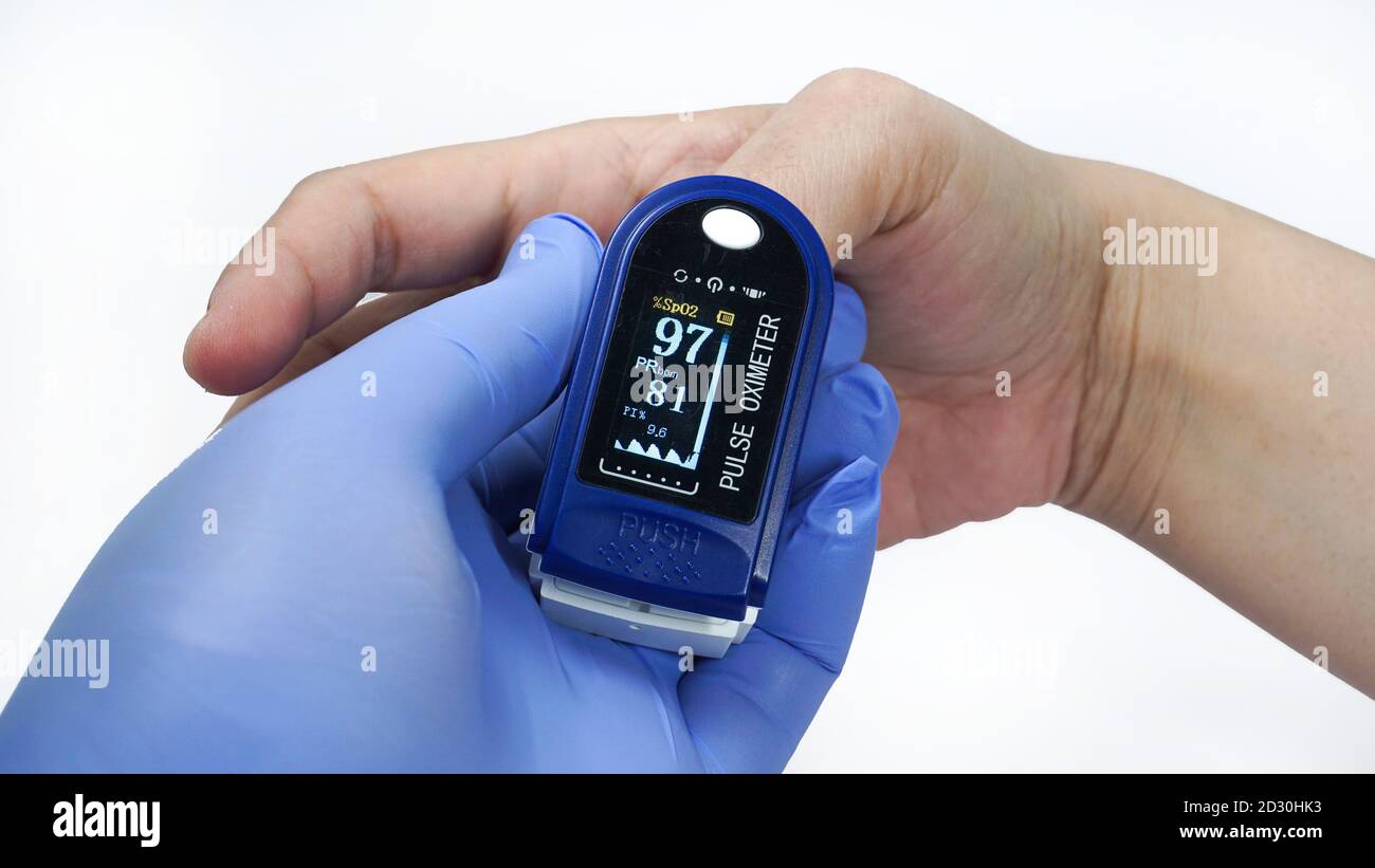 Pulse oximeter used to measure pulse rate and oxygen levels Stock Photo ...