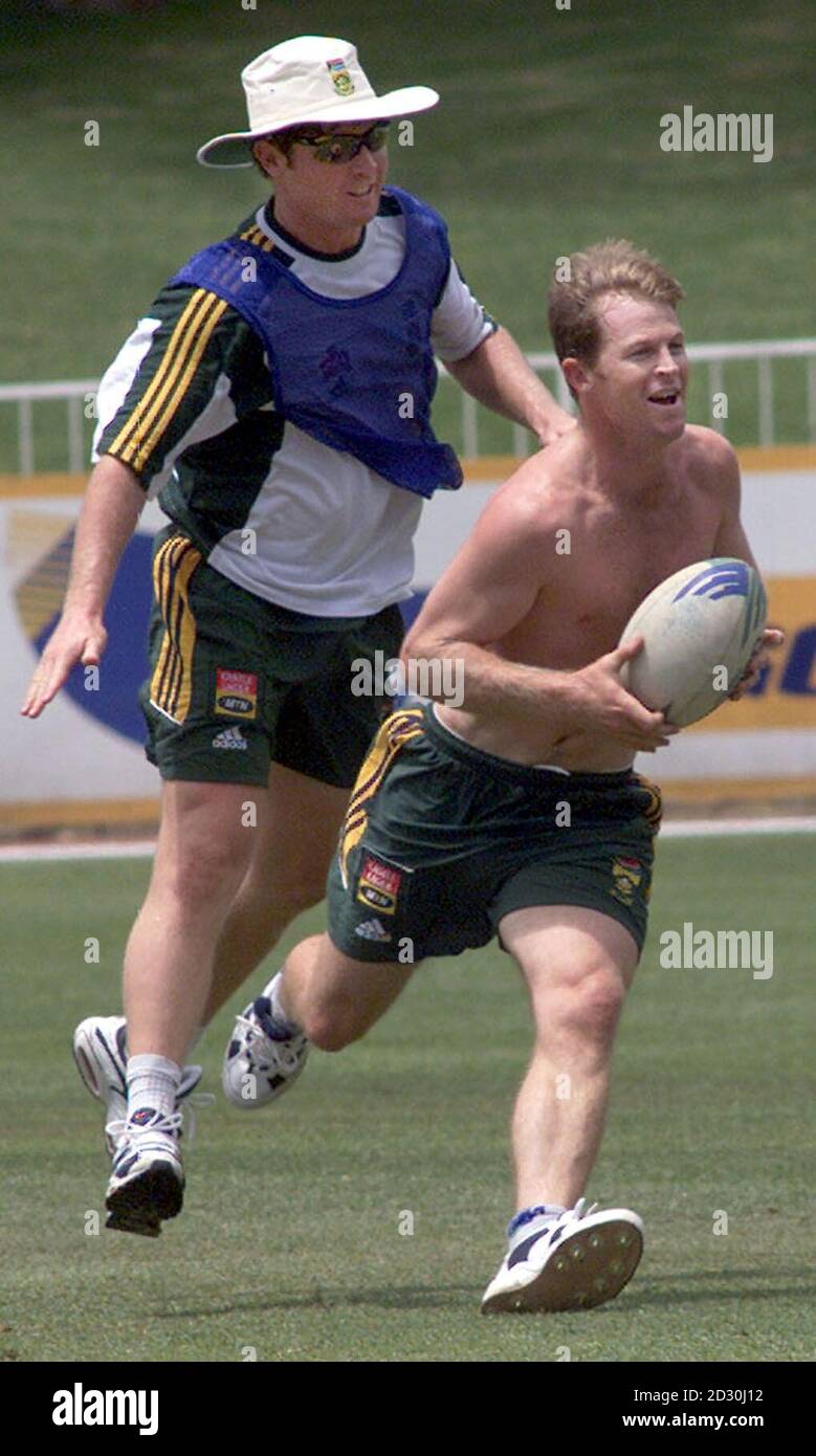 South Africa's Jonty Rhodes runs with a rugby ball from Daryll Cullinan ...