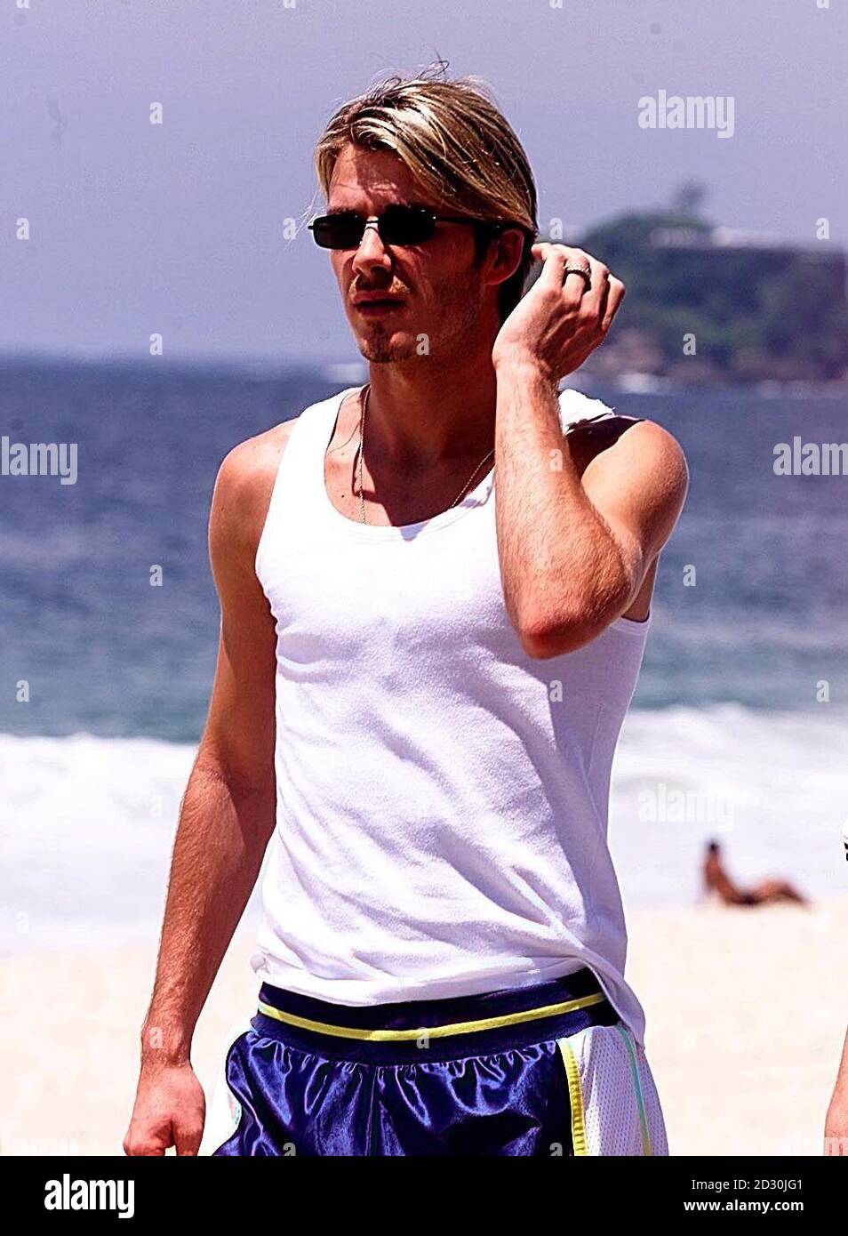 Manchester United footballer David Beckham takes a walk outside the ...