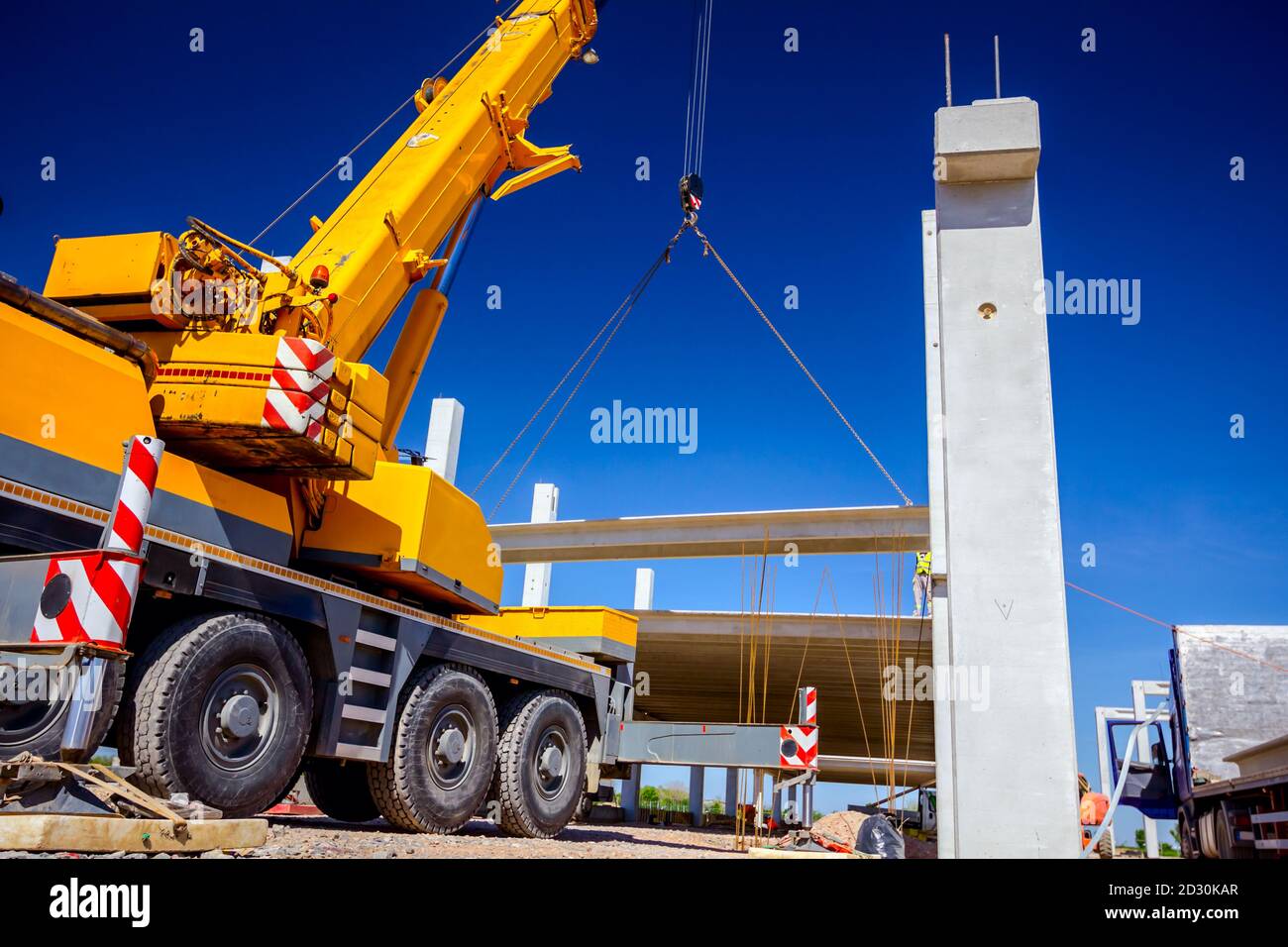 Low angle view on extended side hydraulic outrigger to increase crane ...