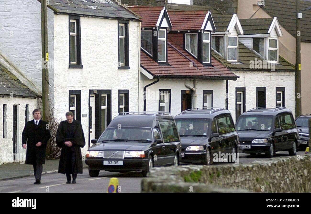 The Reverend Alexander Currie (right) and an undertaker lead the ...