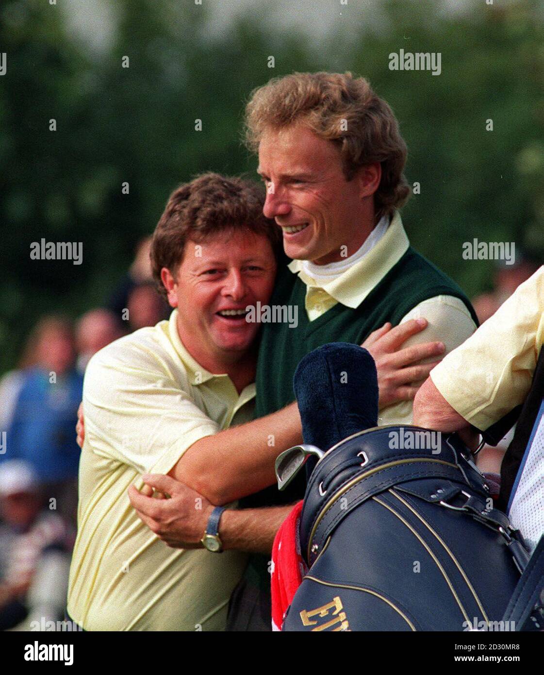 European partners Ian Woosnam and Bernard Langer congratulate each ...
