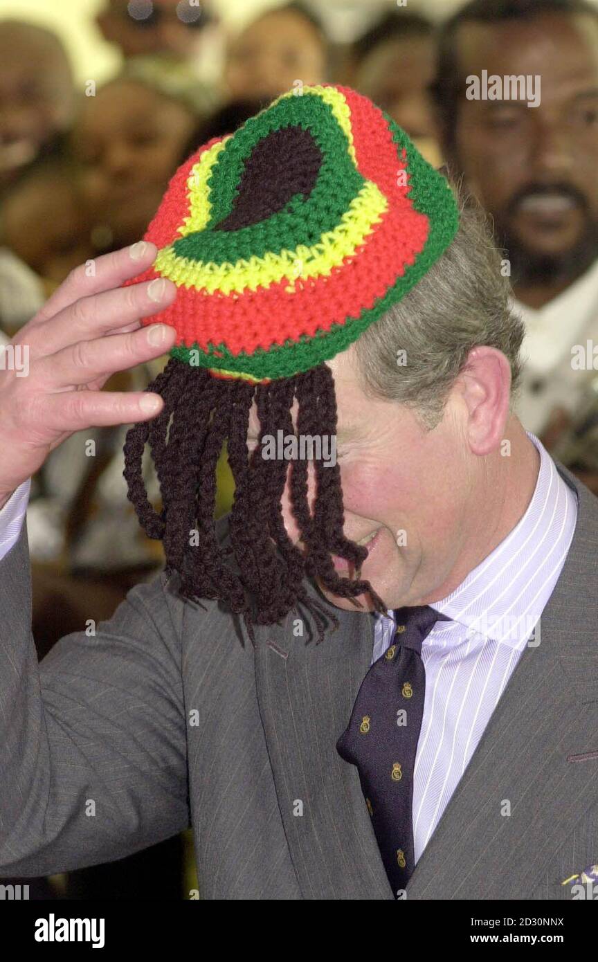 The Prince of Wales laughs with the local Rasta community as he wears a ...