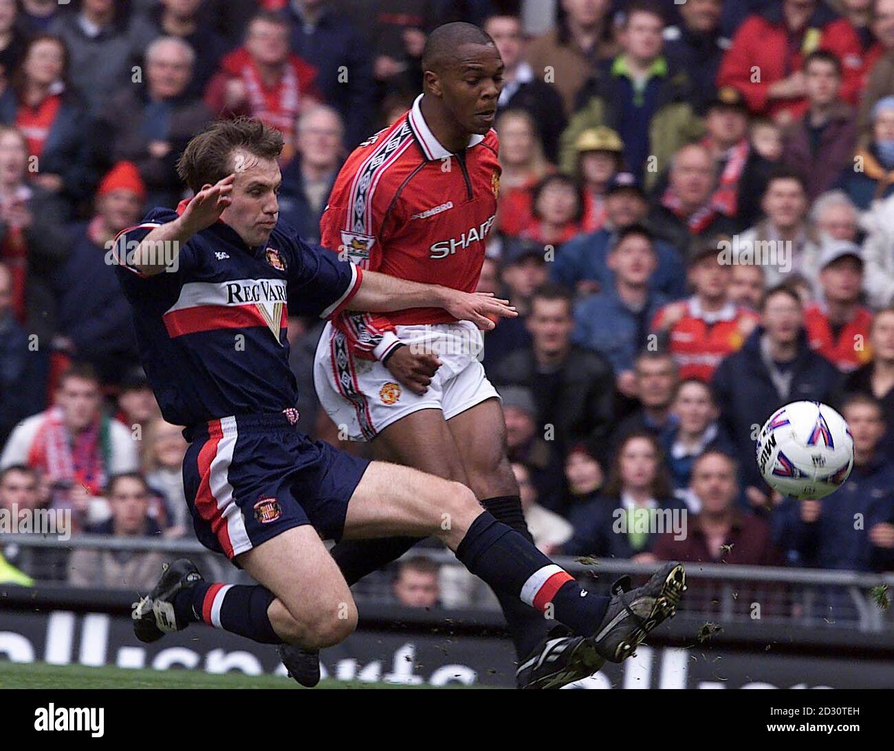 Manchester United's Quentin Fortune (R) takes on Sunderland's Michael ...