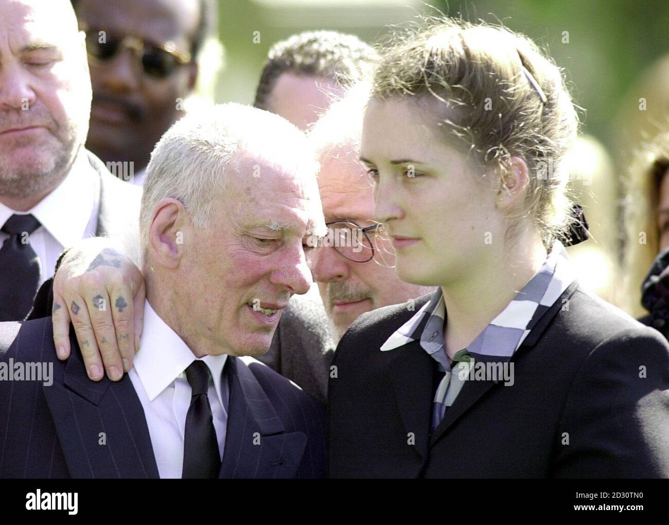 Reggie Kray is comforted by a friend as he stands at the grave of his older brother Charlie with ...
