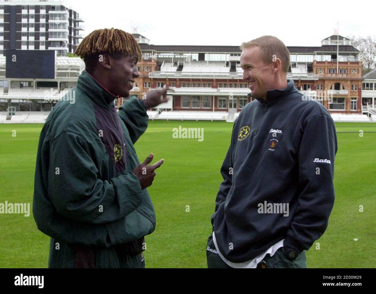 Zimbabwe fast bowler Henry Olonga (left) talks with captain Andy Flower ...
