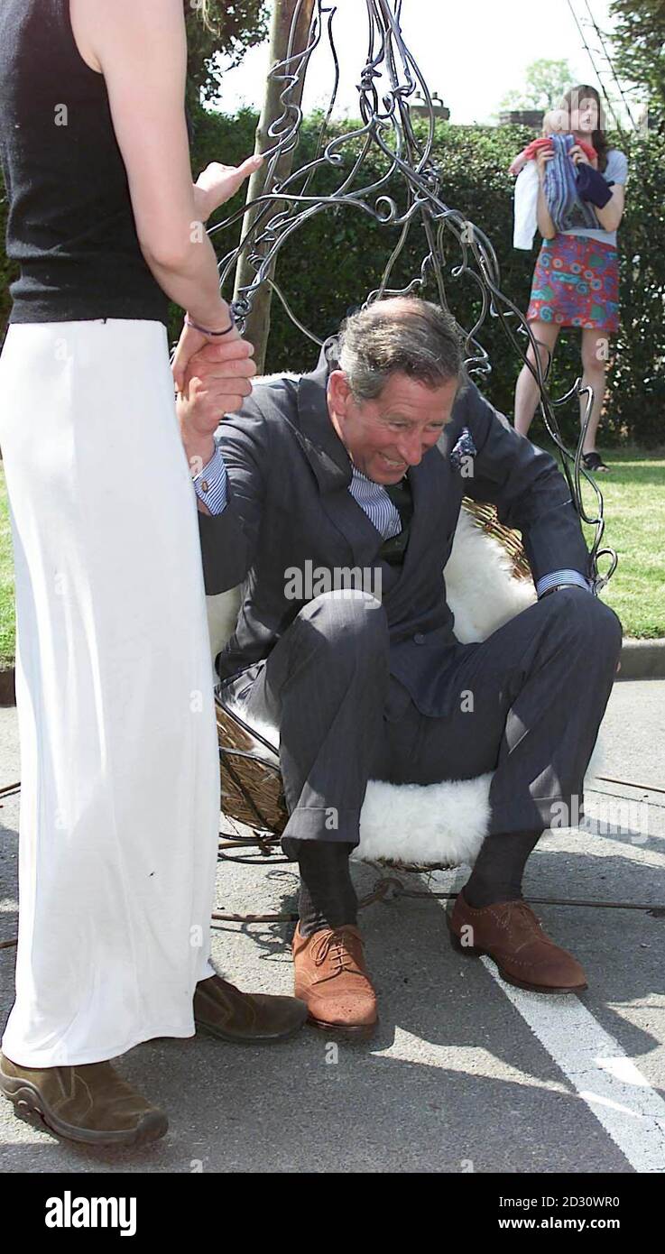 The Prince of Wales, is given a helping hand out of a wrought iron ...