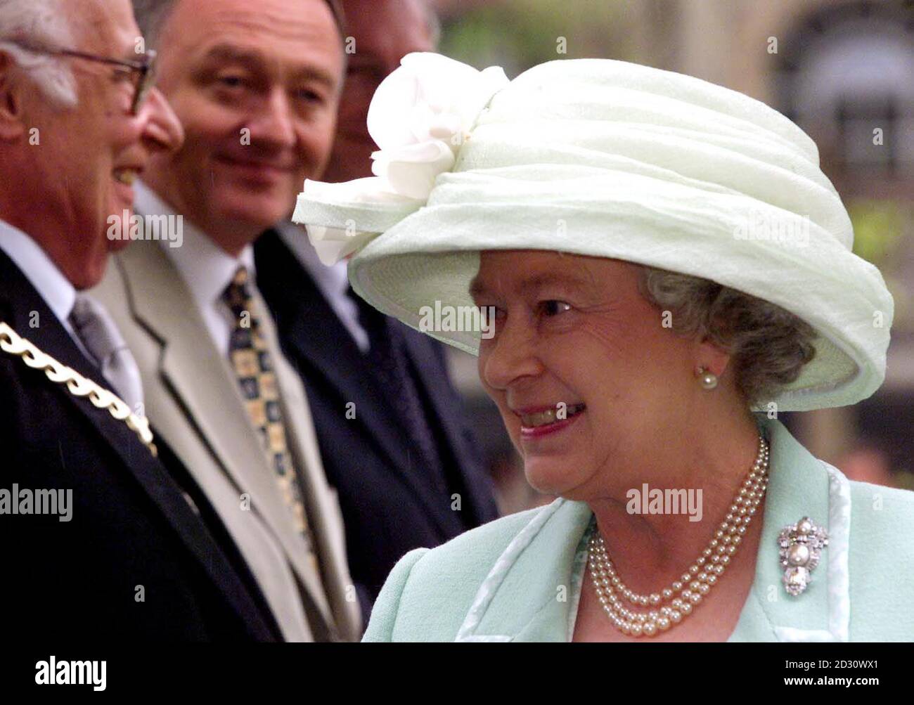Queen Elizabeth II (R) smiles after being greeted by London Mayor Ken ...