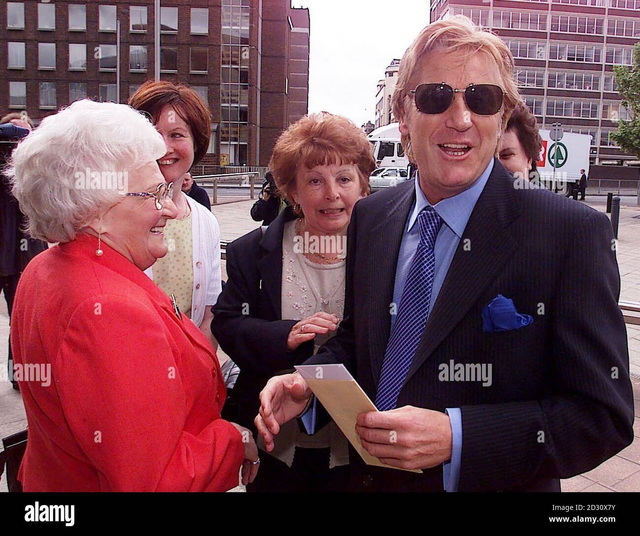 Entertainer Joe Longthorne is met by a group of his fans as he arrives ...
