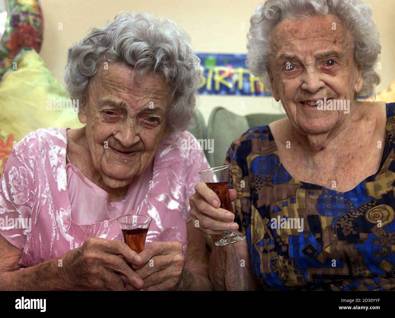 Britain's oldest twins Nellie (L) and Alice Clarke celebrate their ...