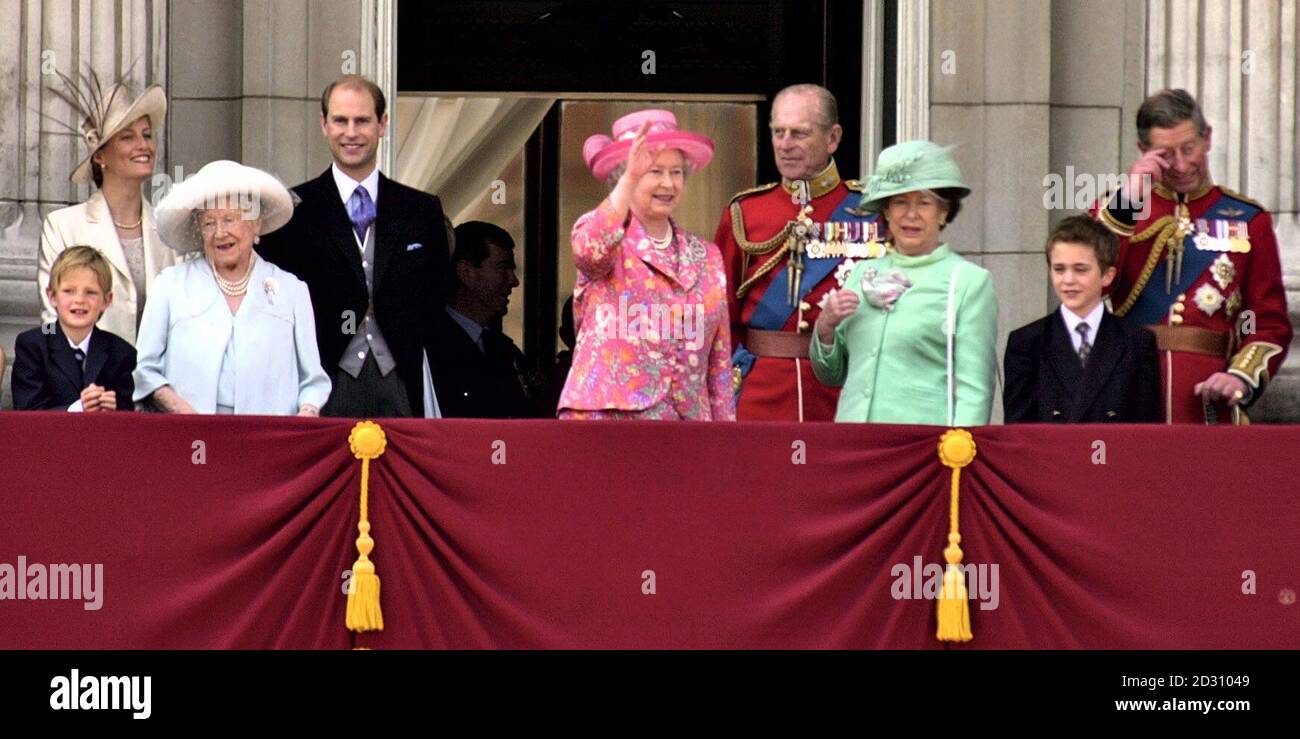 The Queen (C) waves on the balcony of Buckingham Palace, London, for ...