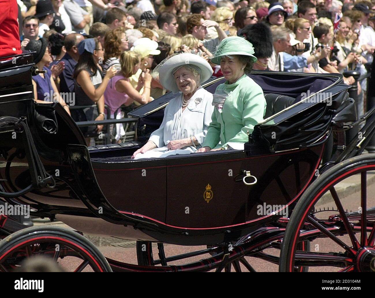 The Queen Mother (L) with Princess Margaret, sit in an open top, horse ...