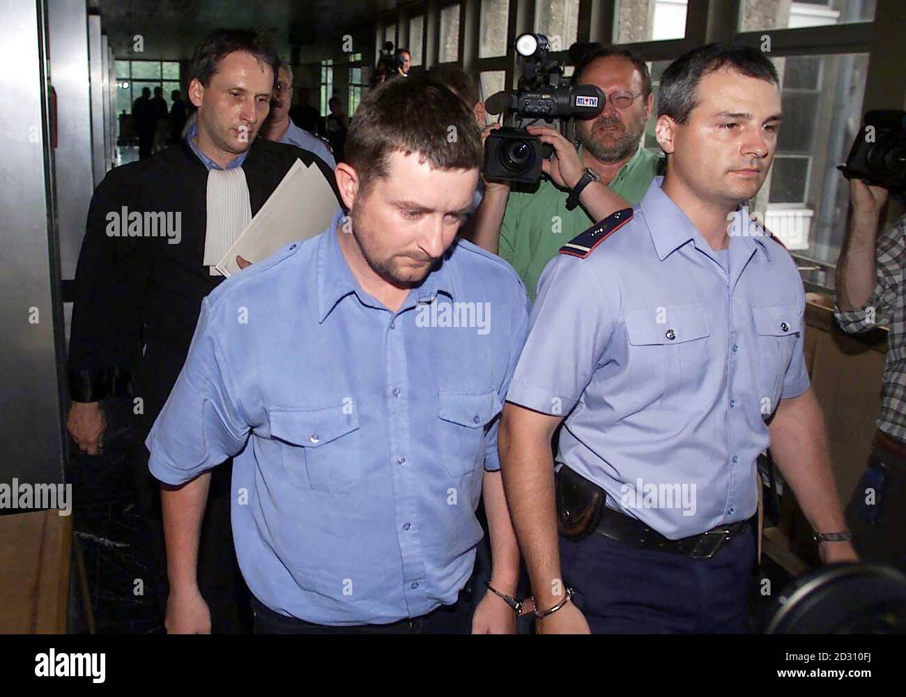 English fan Adrian Brown (L) arrives in handcuffs at the Palais du ...