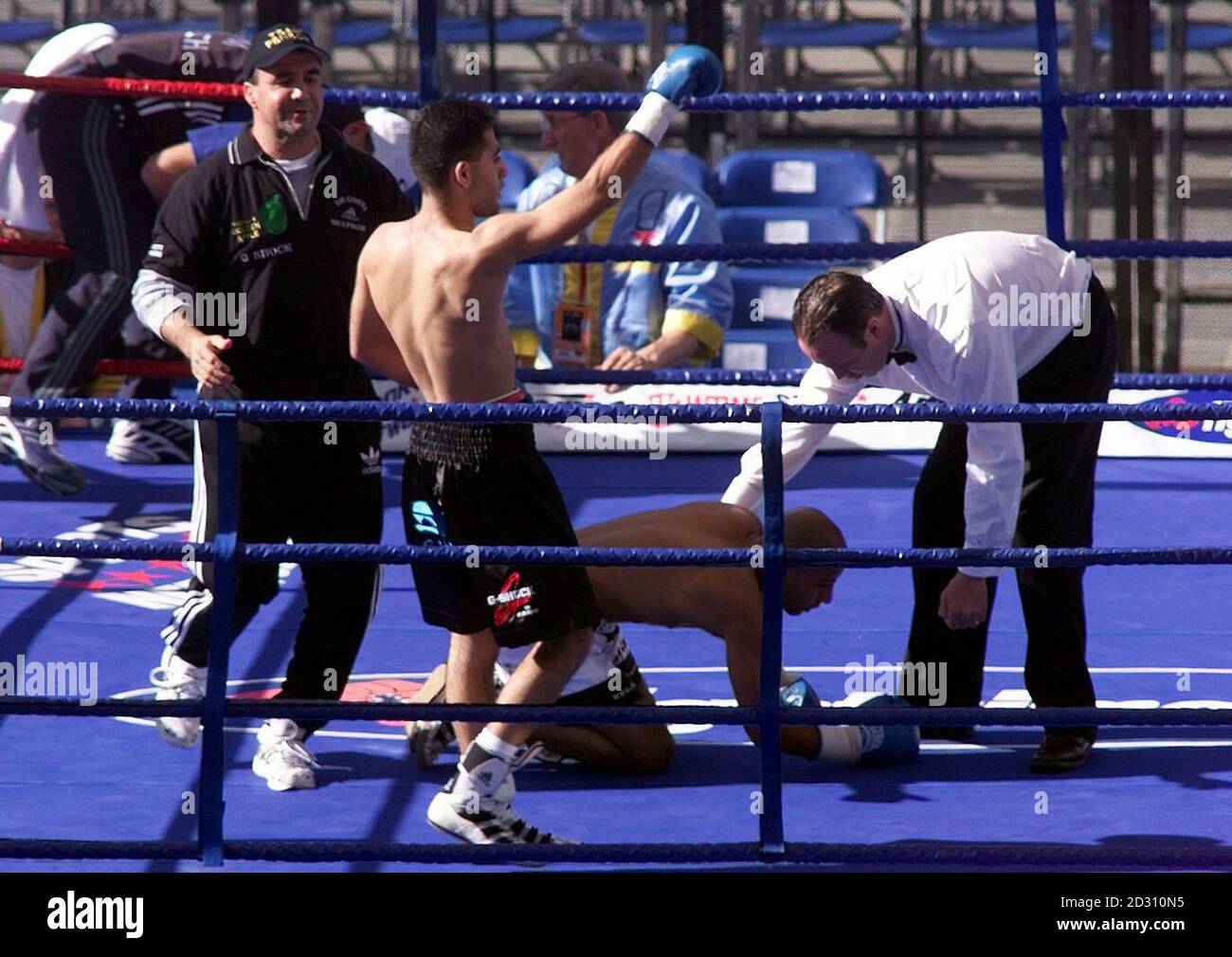 Australian boxer Hussain Hussain raises his hand in victory as he stops ...