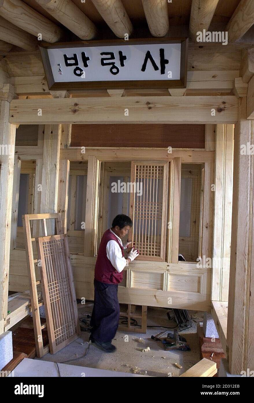 A Korean craftsman working on a sarangbang or scholars studio, which ...