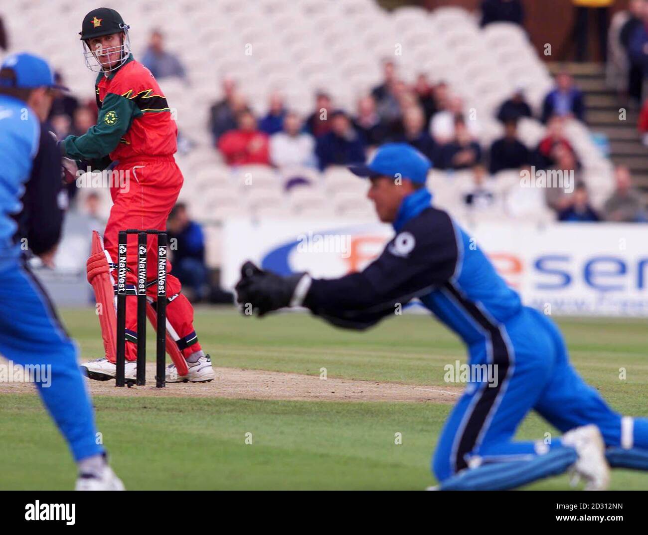 Zimbabwe's Neil Johnson can only watch as he is caught behind by Alec ...