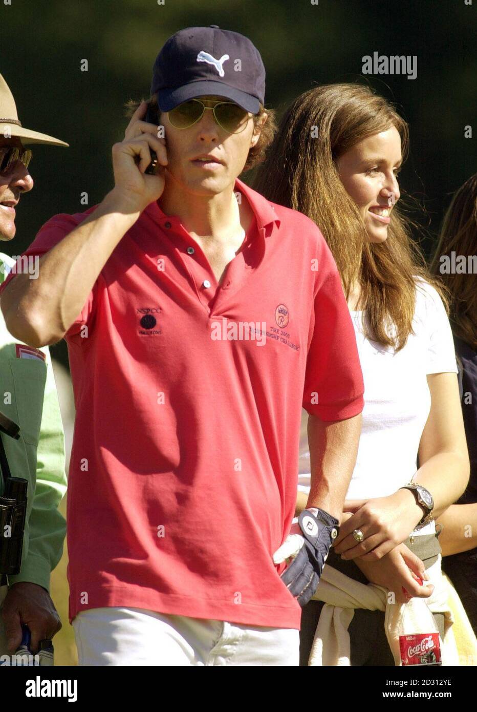 Actor Hugh Grant makes a phone call while standing with Roseanna Innes ...