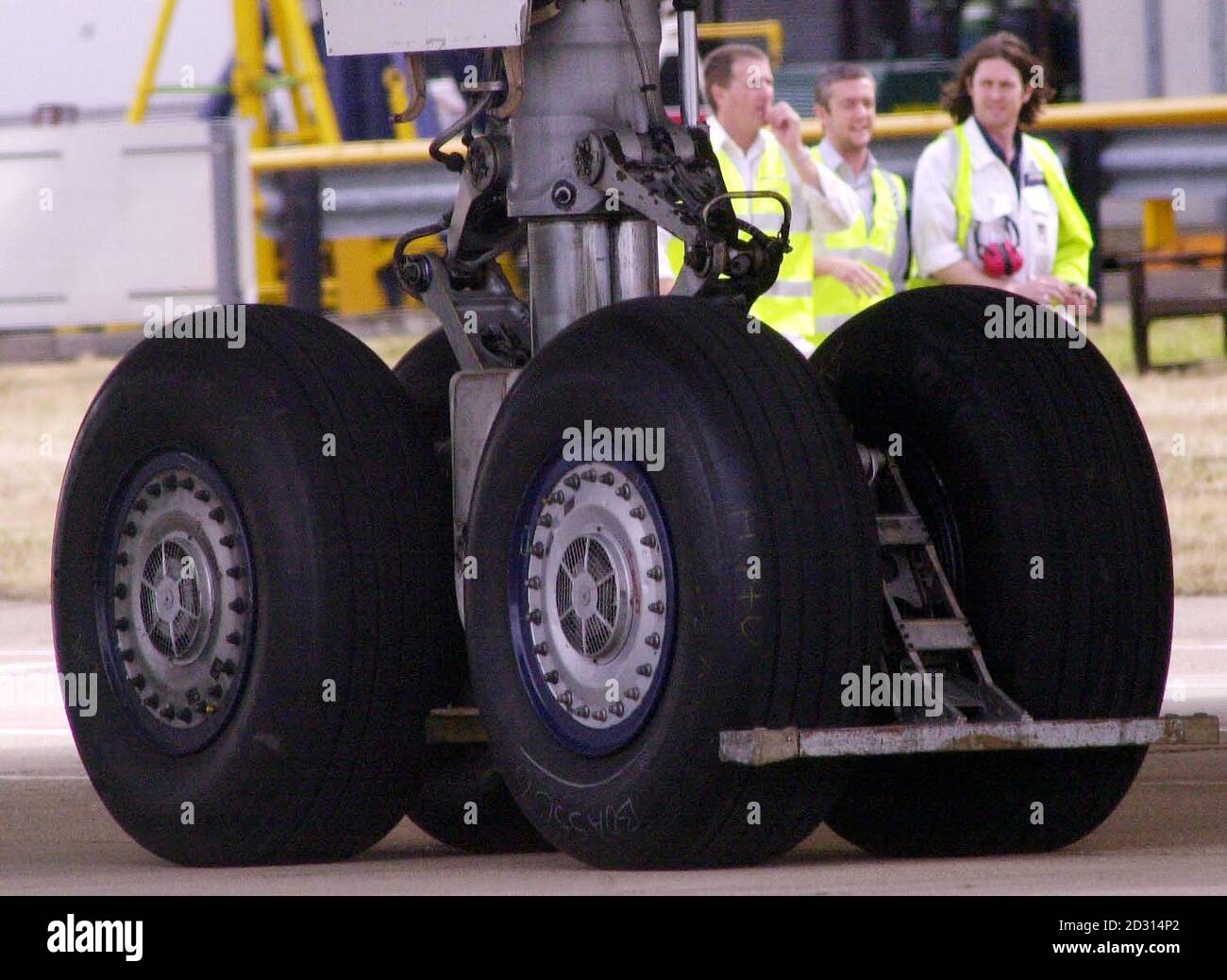 British Airways maintenance personnel walk alongside a grounded ...