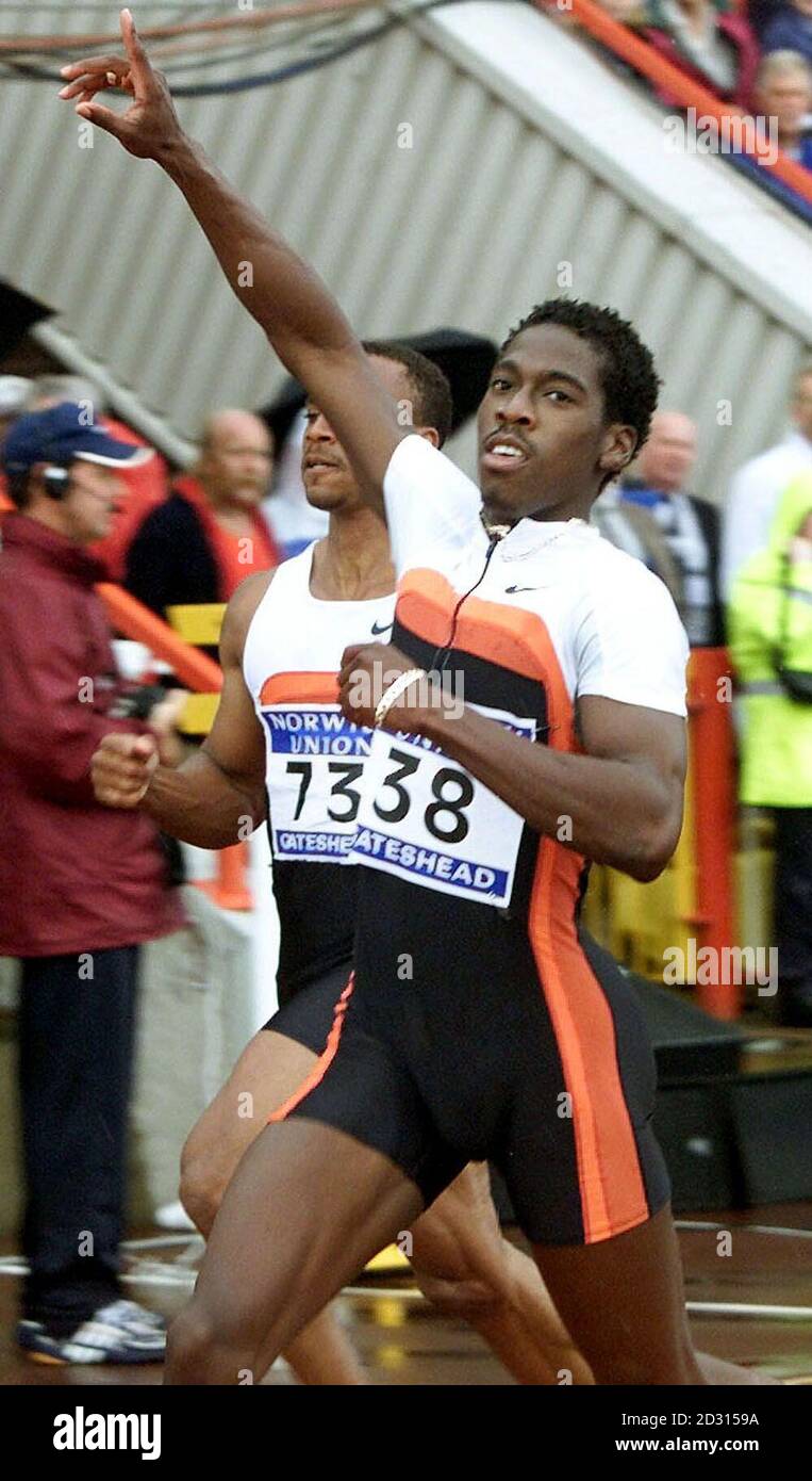 Britain's Christian Malcolm celebrates as he crosses the line to win ...