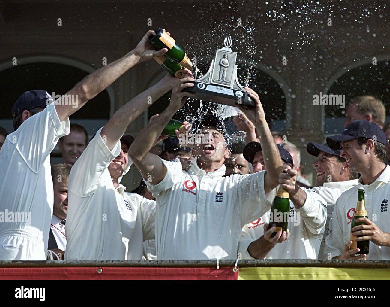 England captain Nasser Hussain holds the Wisden trophy as his team ...