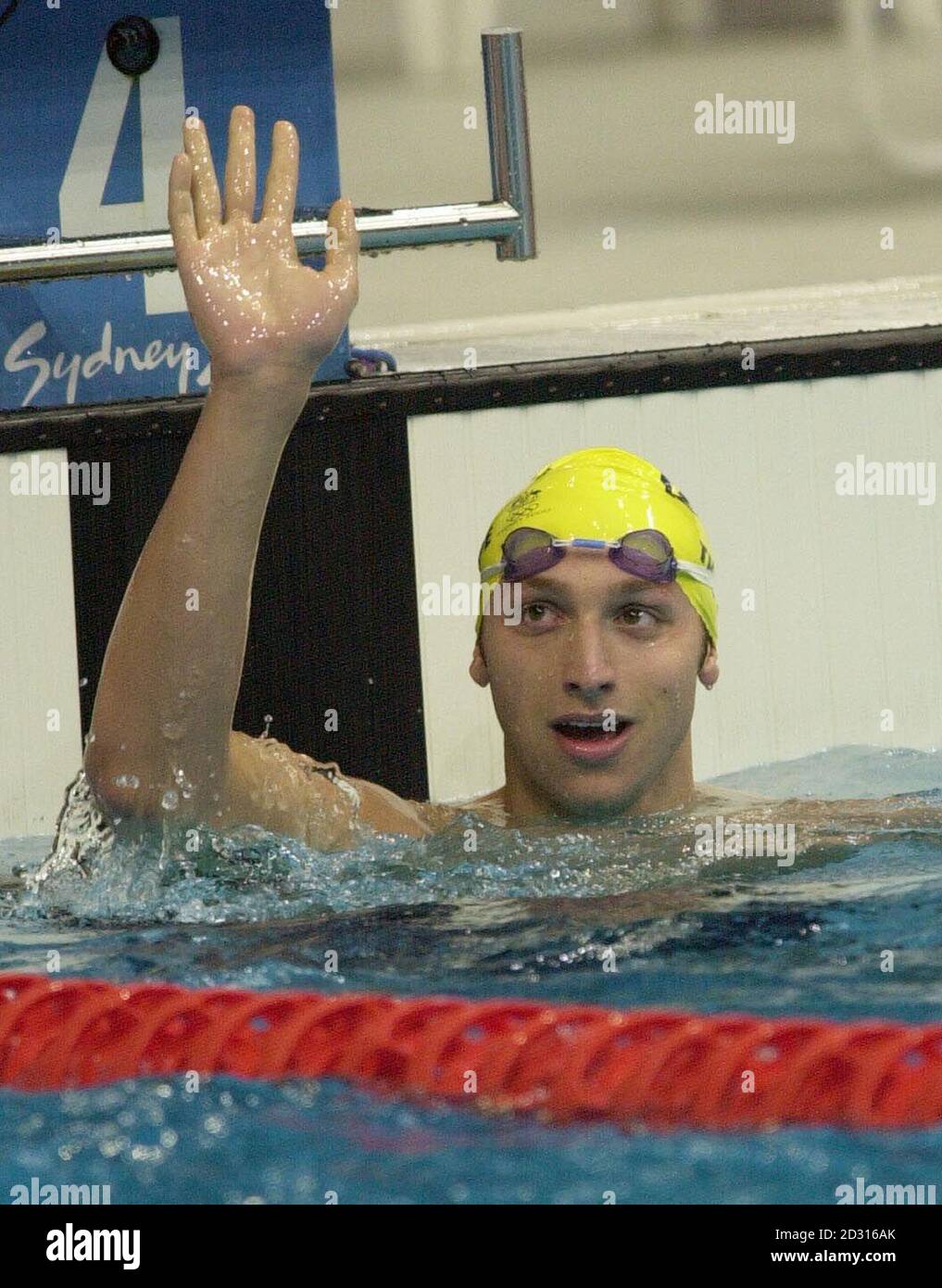 Australia's Ian Thorpe waves to the crowd after slicing 0.35 off the ...