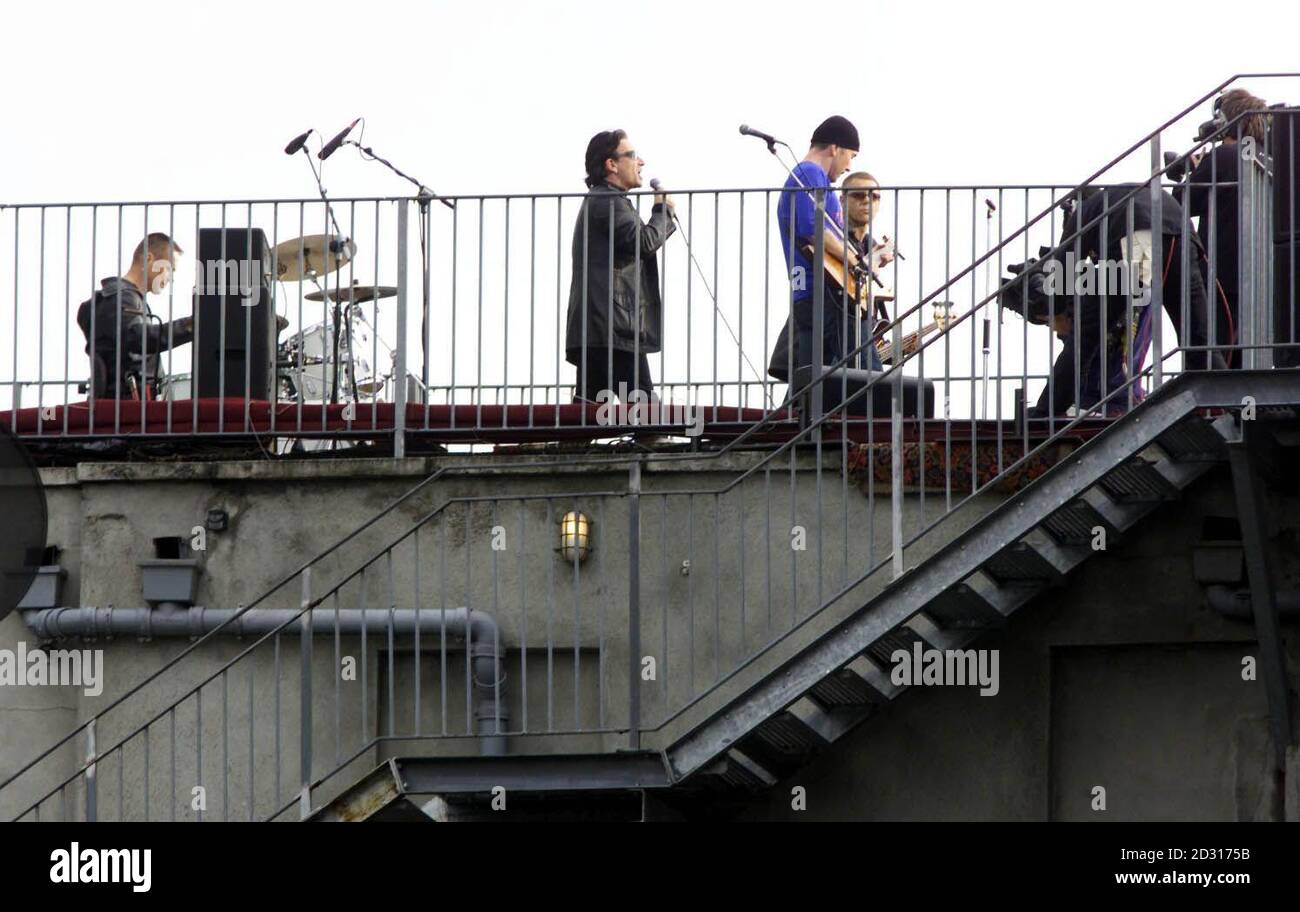 Irish pop group U2 giving a live performence from the roof-top of the ...
