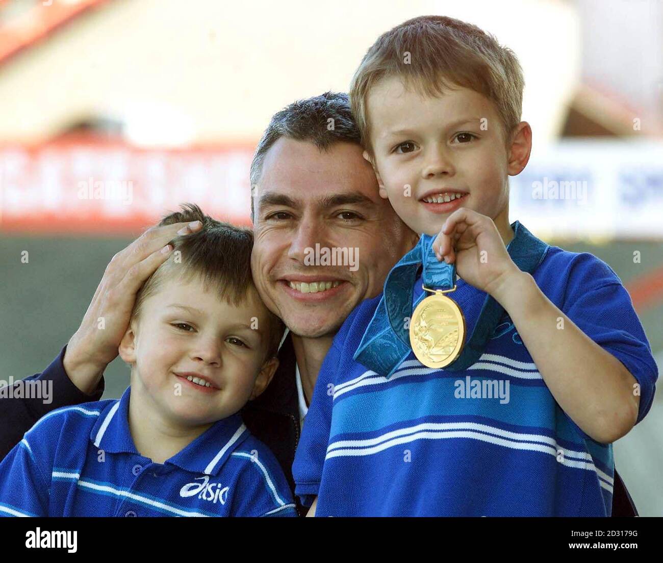 Triple Jump Olympic Gold medalist Jonathan Edwards shows off his medal ...