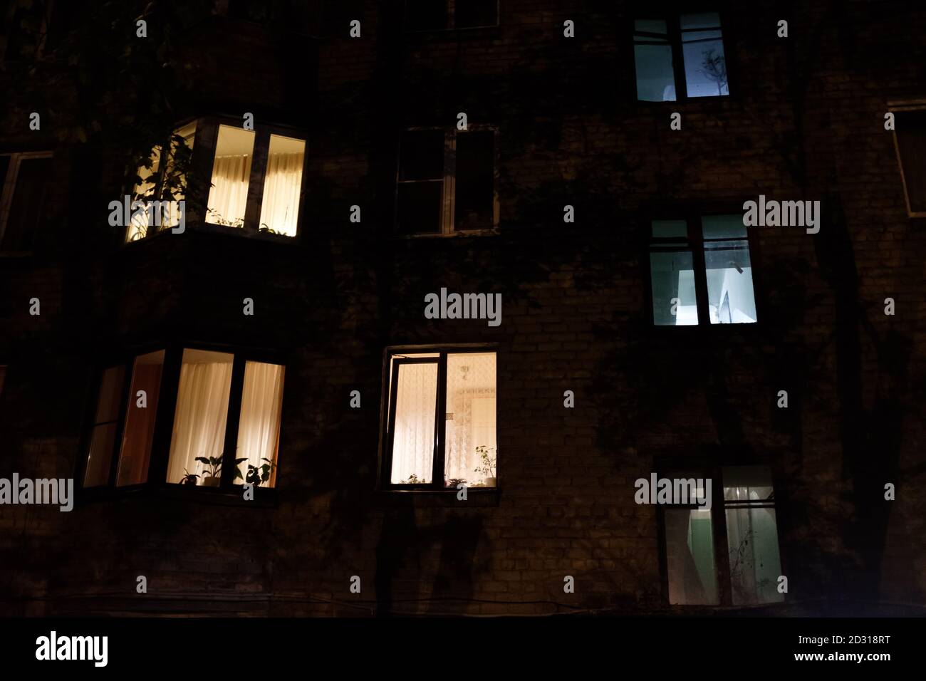 glowing windows in a residential multi-storey building at night Stock ...