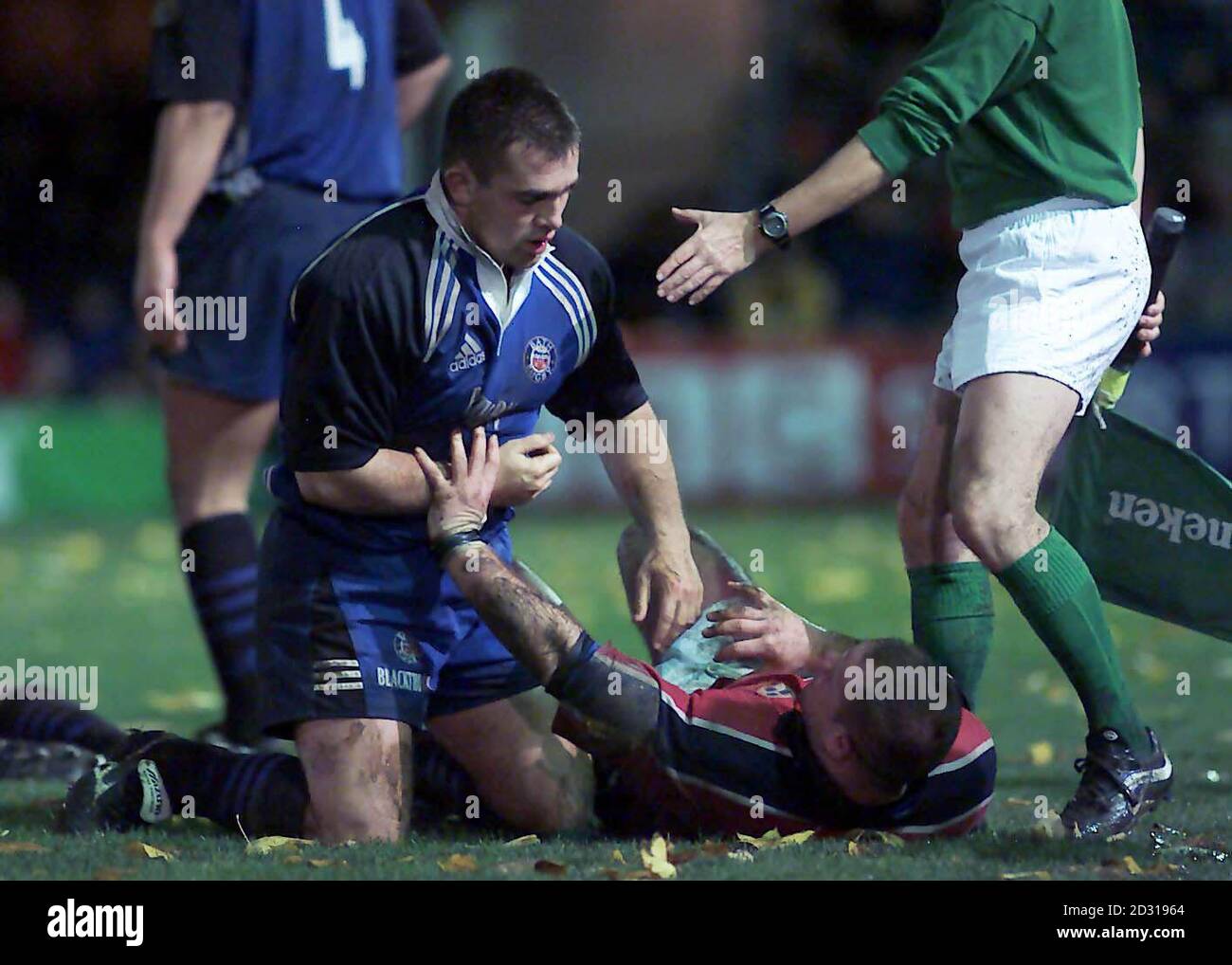 The linesman steps in to break up Simon Emms for Bath (blue and black ...