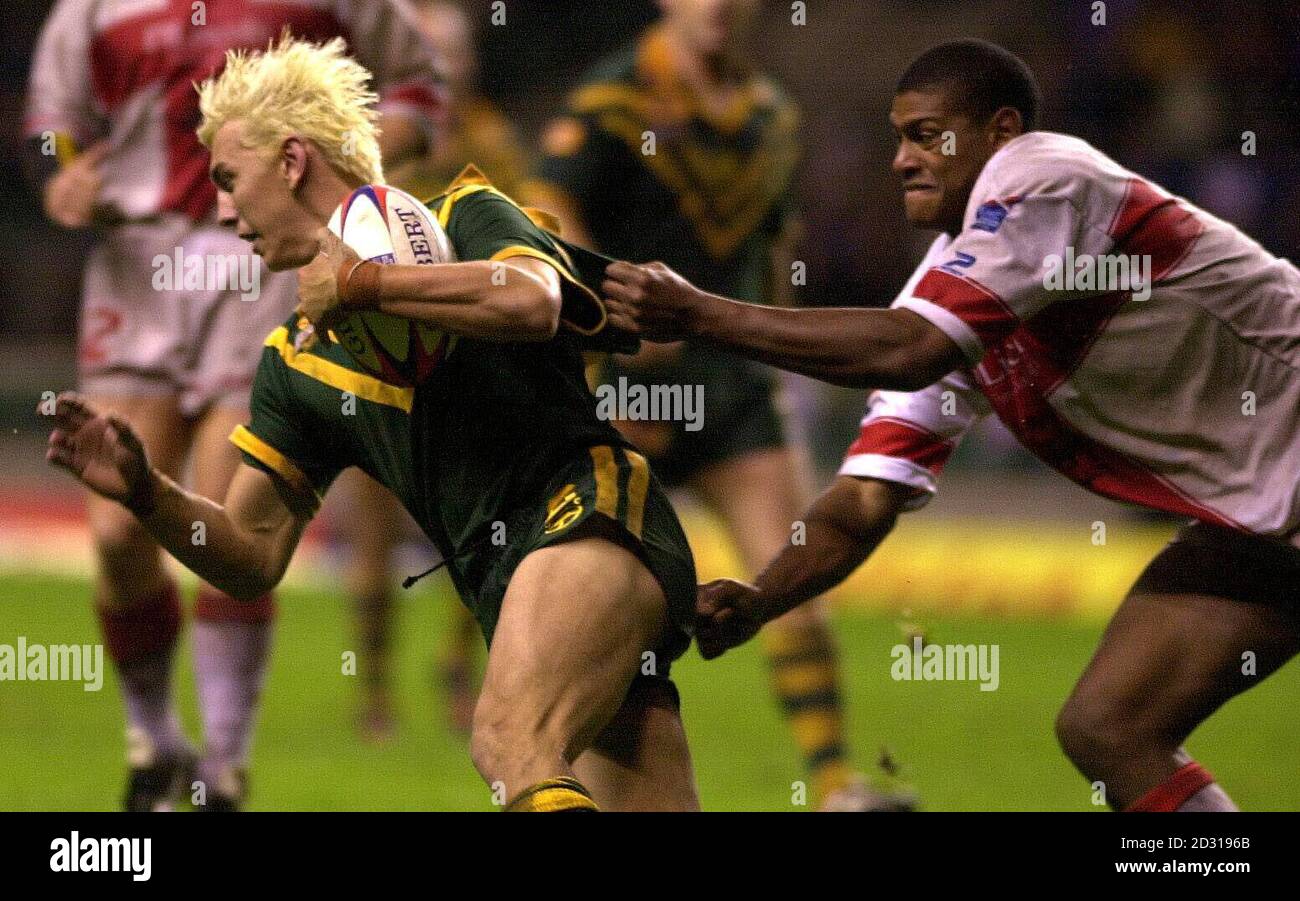 Leon Pryce (right) of England tries to get to grips with Adam MacDougal ...