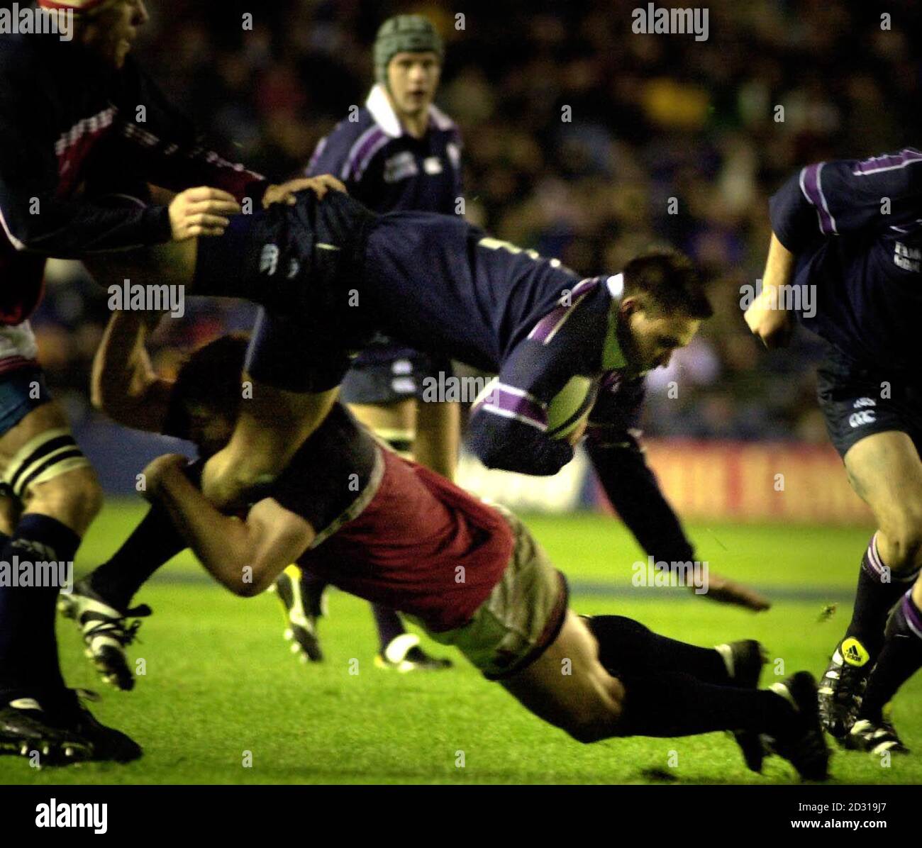 USA Eagles Dan Lyle takes the legs of Scotland`s John Steel during ...