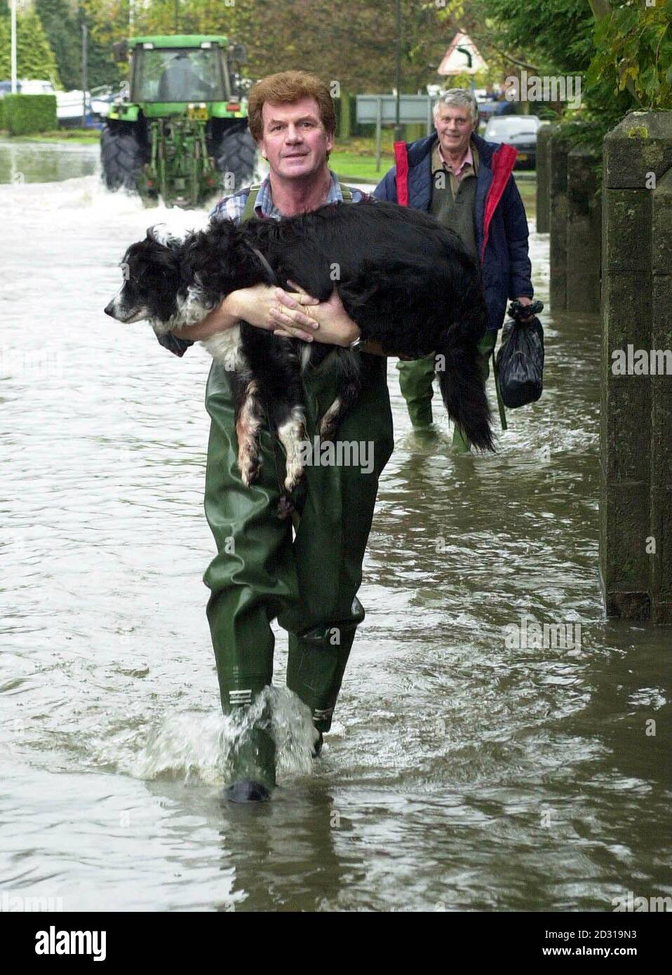 Neil Culley carries his friend's dog "Girlie" who is 18 years old blind ...