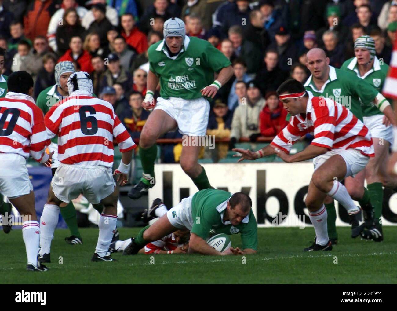 Ireland's prop Peter Clohessy is brought down by the Japanese defence ...