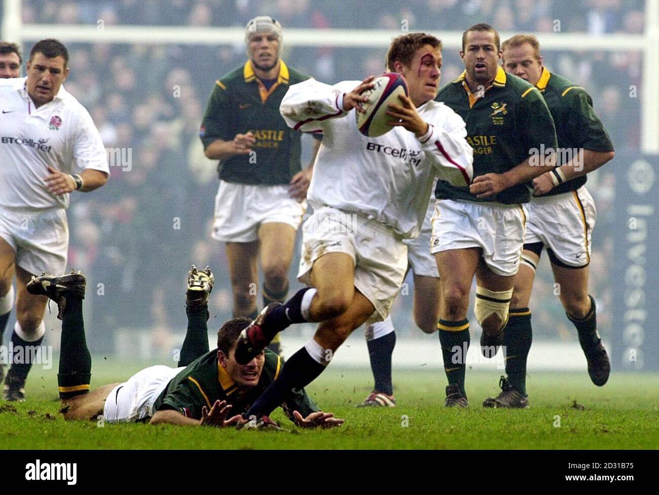 England's Jonny Wilkinson (foreground), with blood on his face from an ...