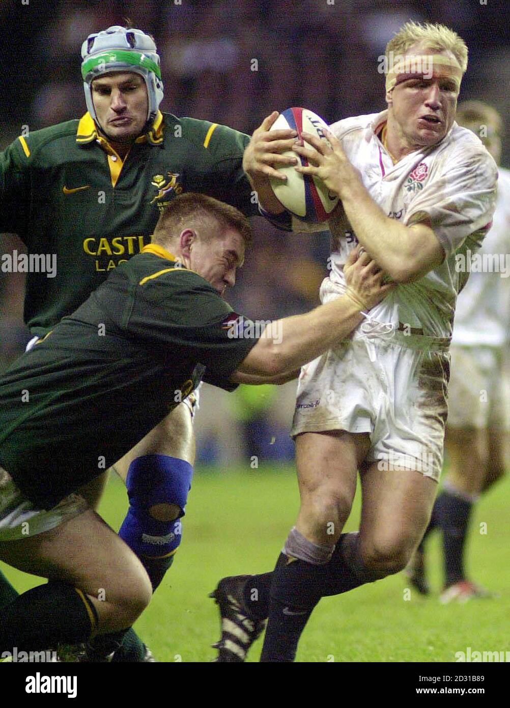 England's Neil Back (right) breaks through the South African defence ...