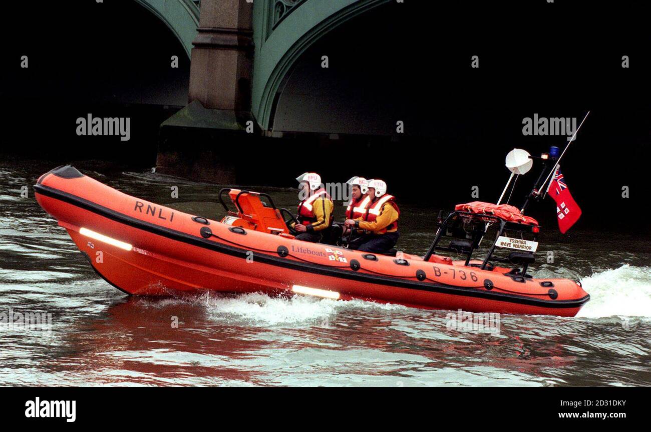 RNLI lifeboat crew on board an in-shore lifeboat on the River Thames ...