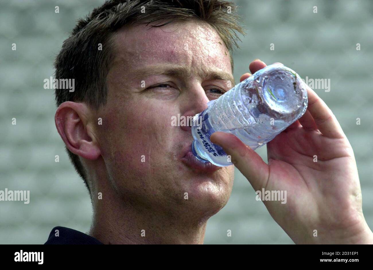 England bowler Ashley Giles takes a drink of water to cool down in the ...