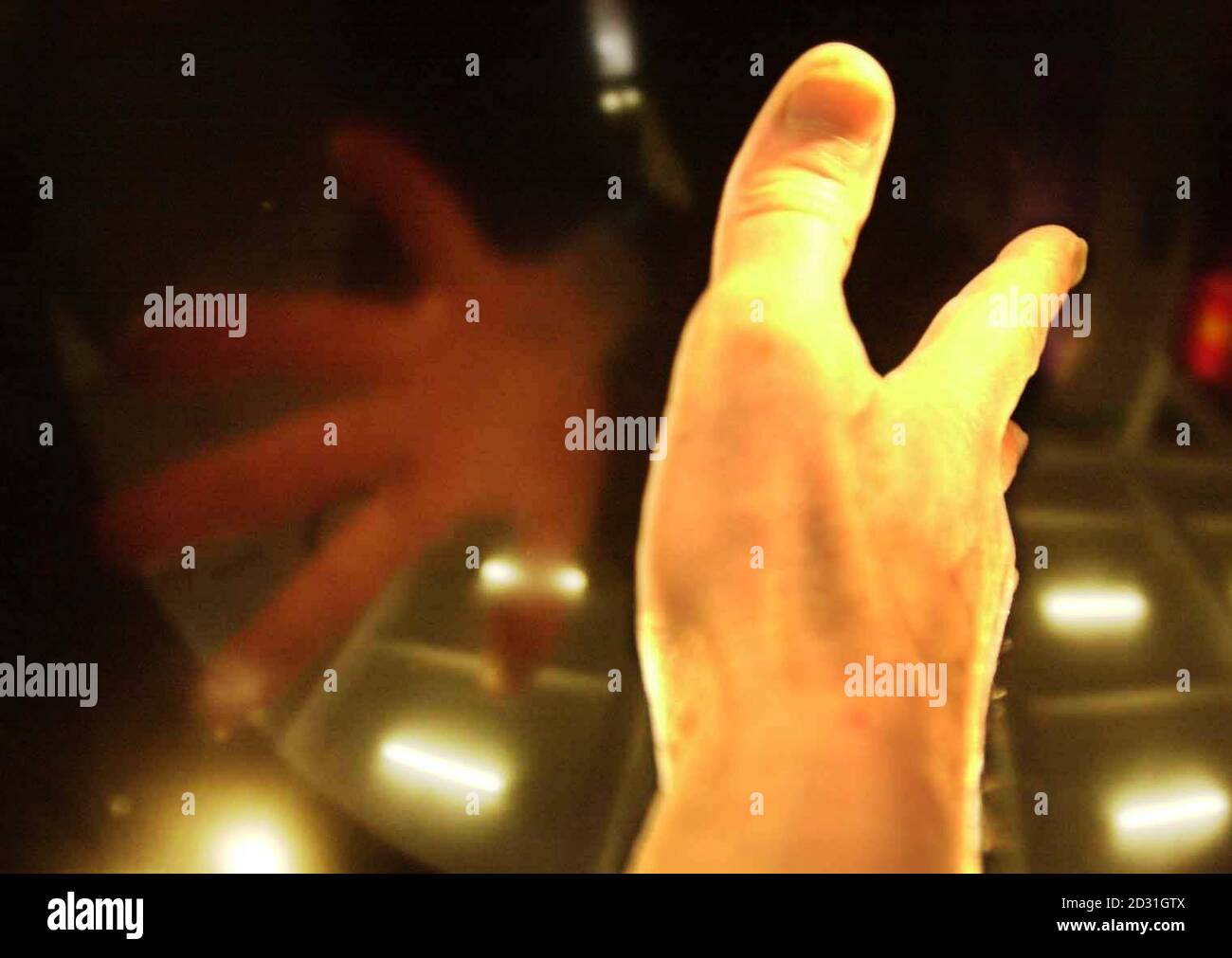 A ghostly 3D 'real' image of a hand emerges from a parabolic reflector ...