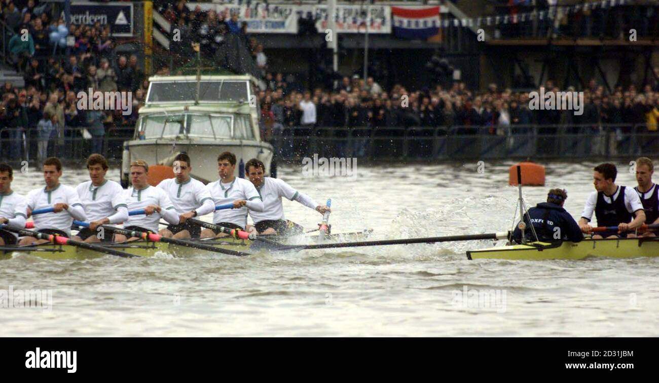 Oxford and Cambridge (L) Boat crews clash oars at the start of the ...
