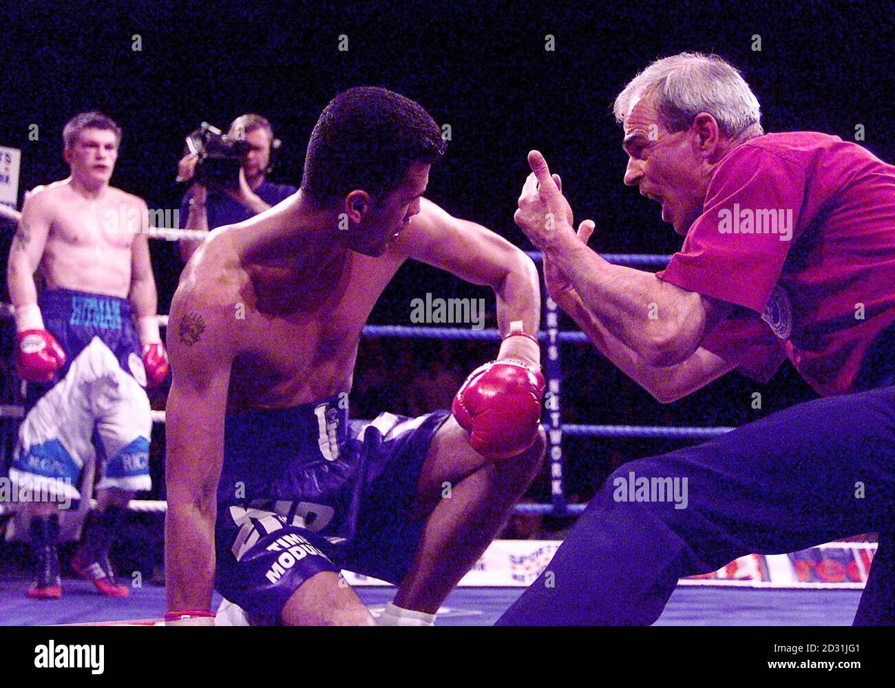 Canada's Tony Pep (centre) takes a count in the third round as Ricky ...