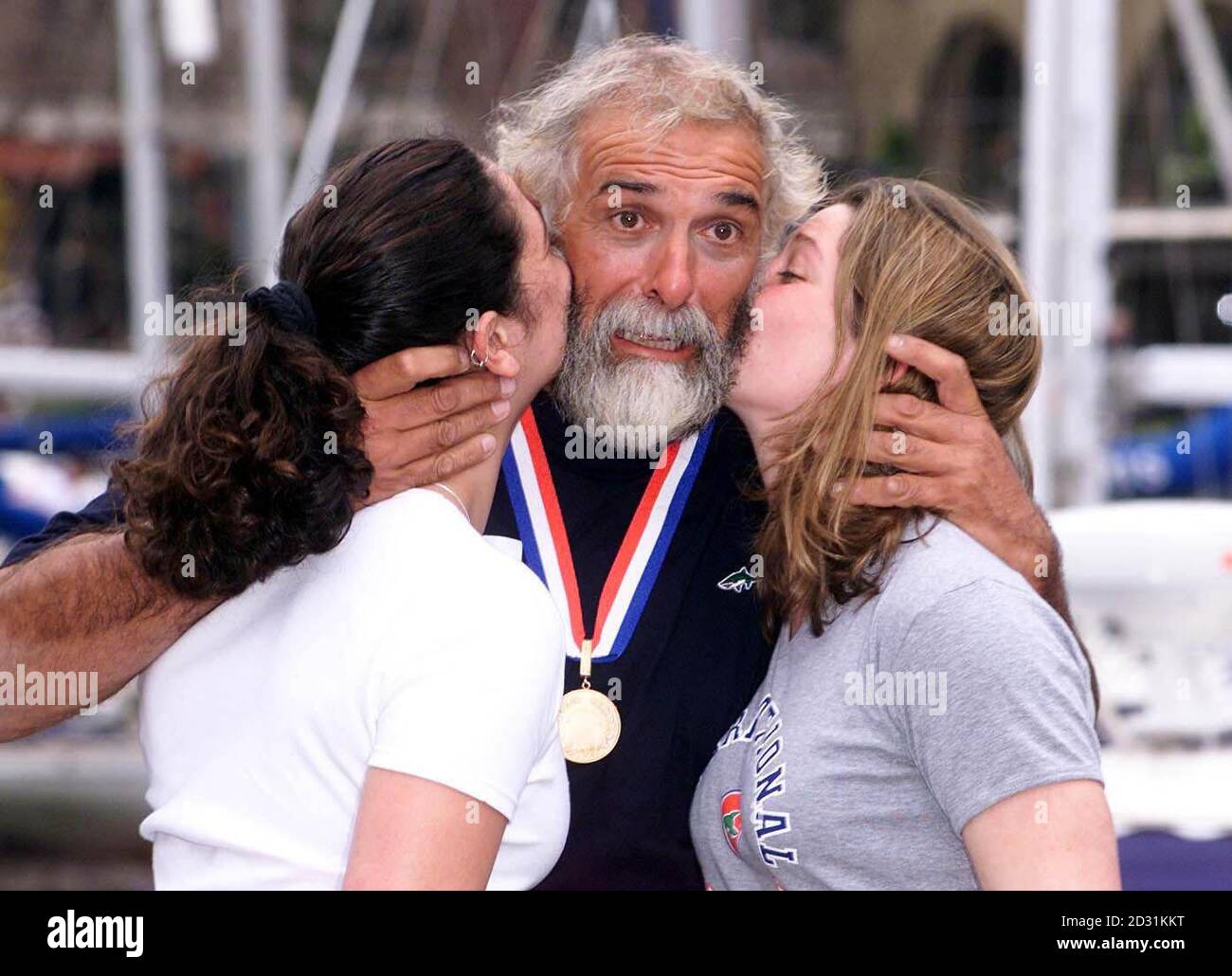 British rower Jim Shekhdar gets a kiss from his daughters, Sarah (L ...