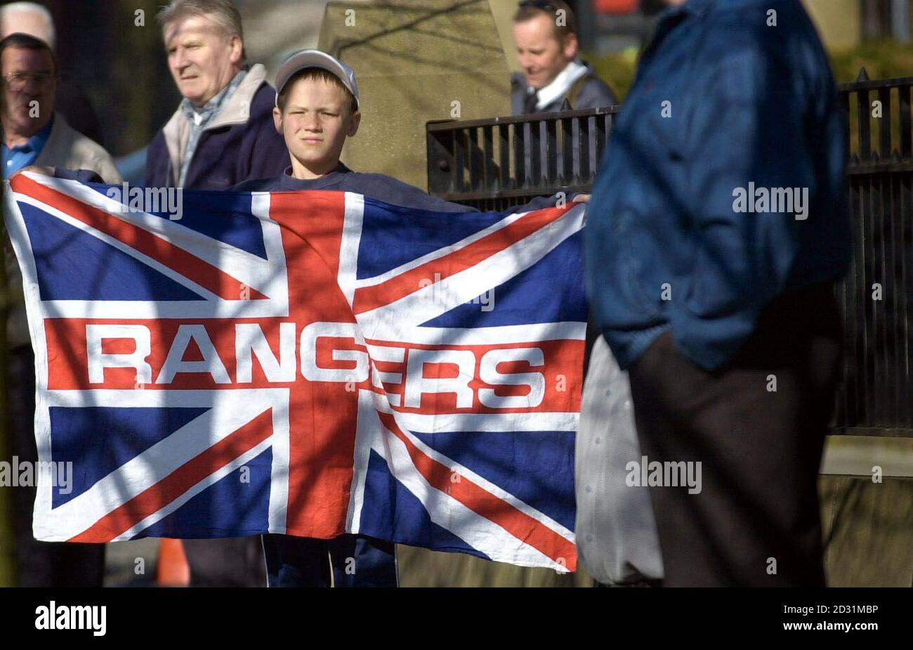 A young fan holds up a Rangers flag at the funeral of Rangers legend ...