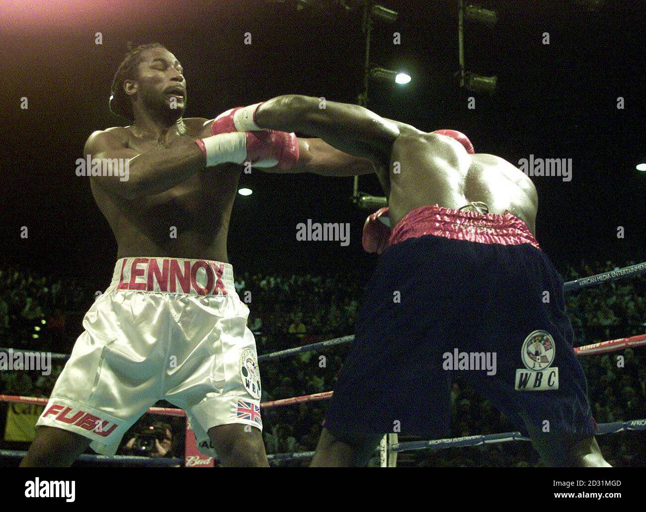 Lennox Lewis (left) takes a left on the chin from Hasim Rahman during ...
