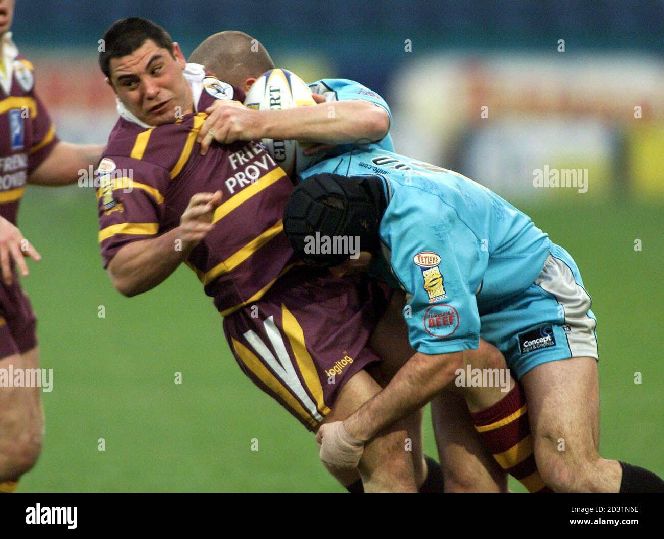 Hull's Jason Smith (back) and Deon Bird tackle Huddersfield's David ...
