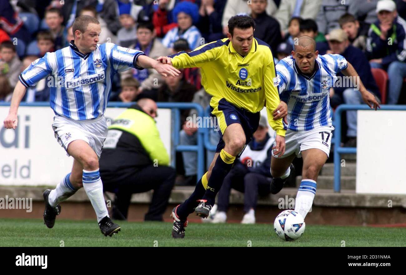 Huddersfield's Chris Holland (left) and Simon Baldry (right) tussle for ...